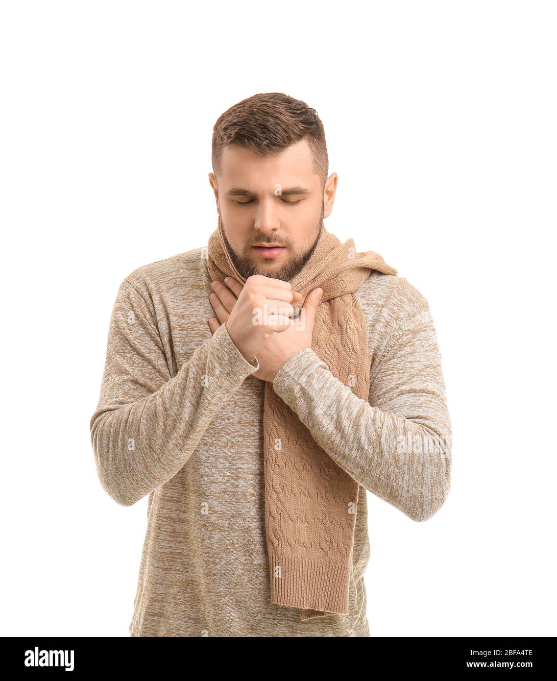 Coughing young man on white background Stock Photo - Alamy