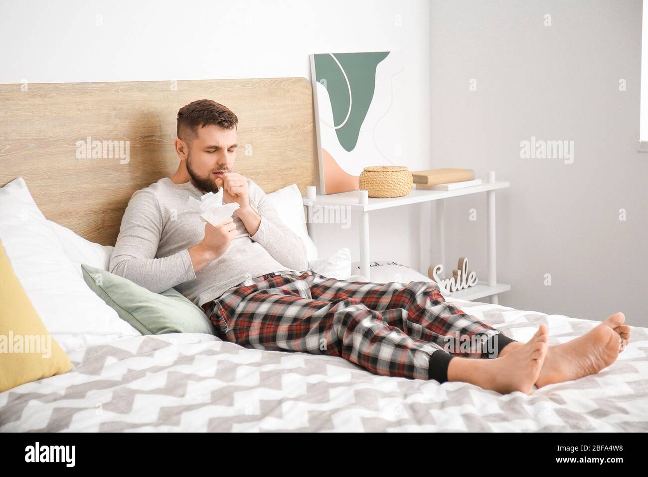 Ill young man at home Stock Photo - Alamy