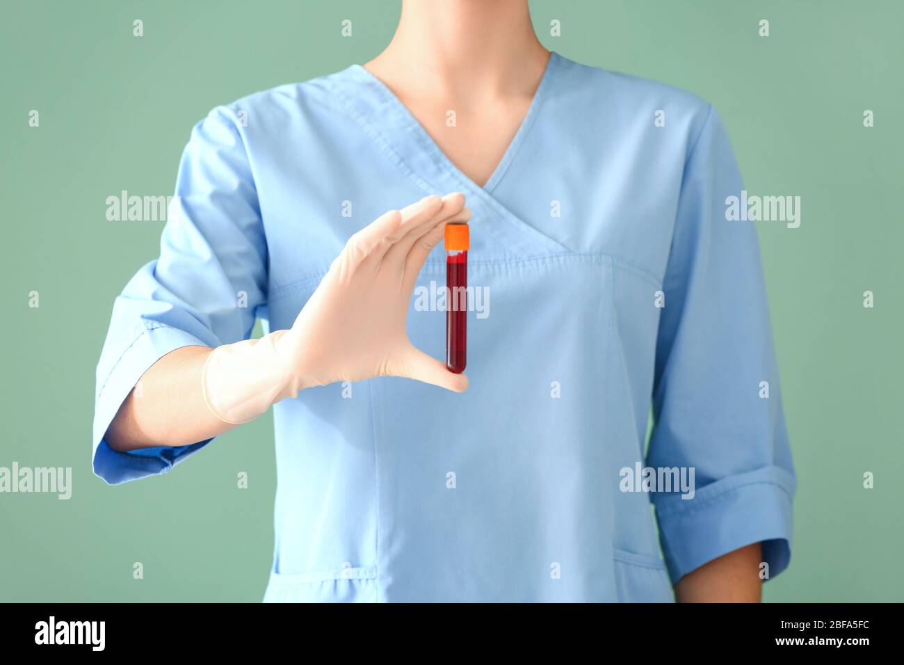 Doctor holding test tube with blood sample on color background Stock ...