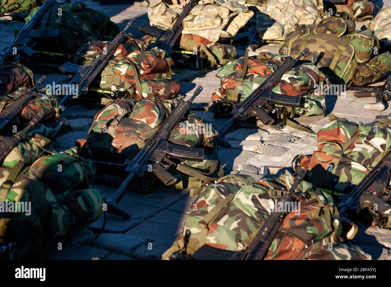 Stacked Military bags and rifles on the road. On the Republic.Day of ...