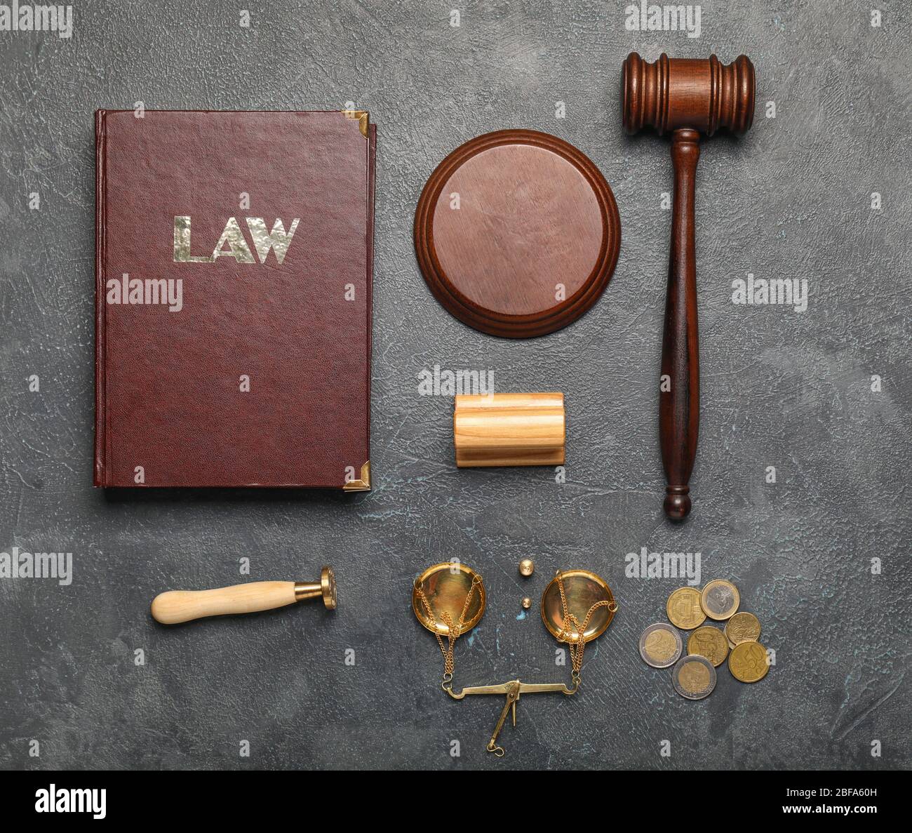 Judge's gavel, stamps, book and scales of justice on grey background ...