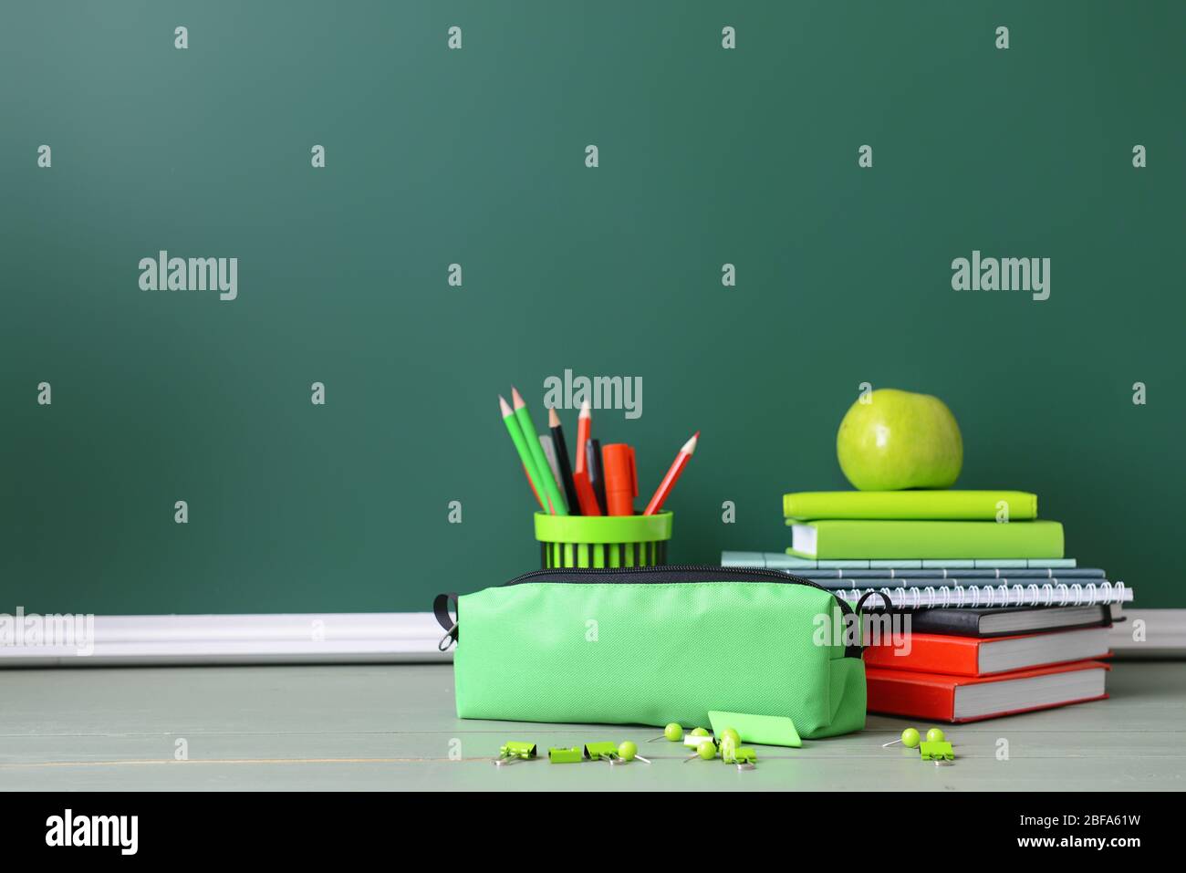 Pencil bag with stationery on desk in classroom Stock Photo - Alamy