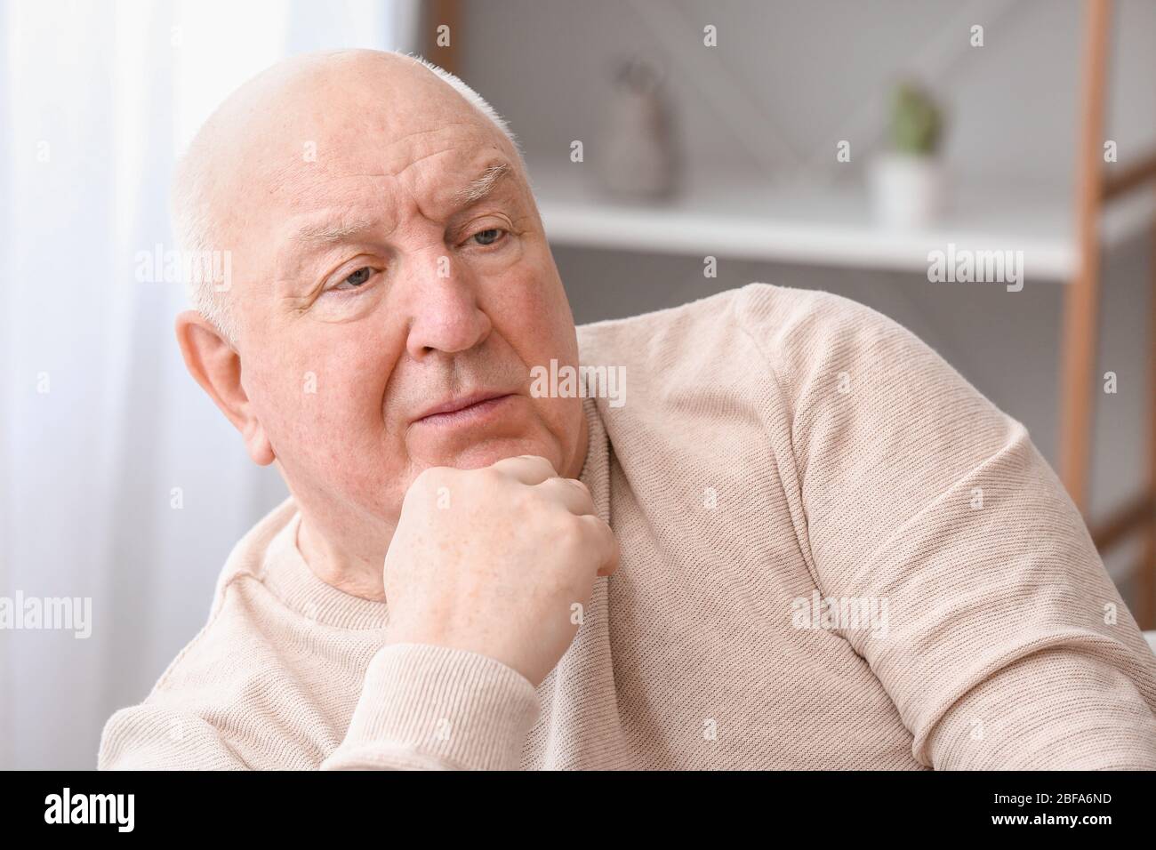 Elderly man suffering from mental disability at home Stock Photo - Alamy