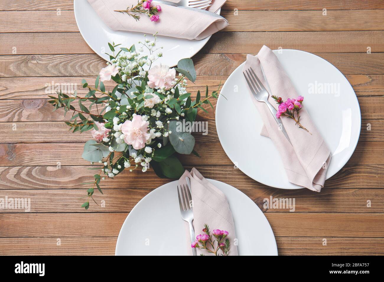 Beautiful table setting with floral decor on wooden background Stock ...