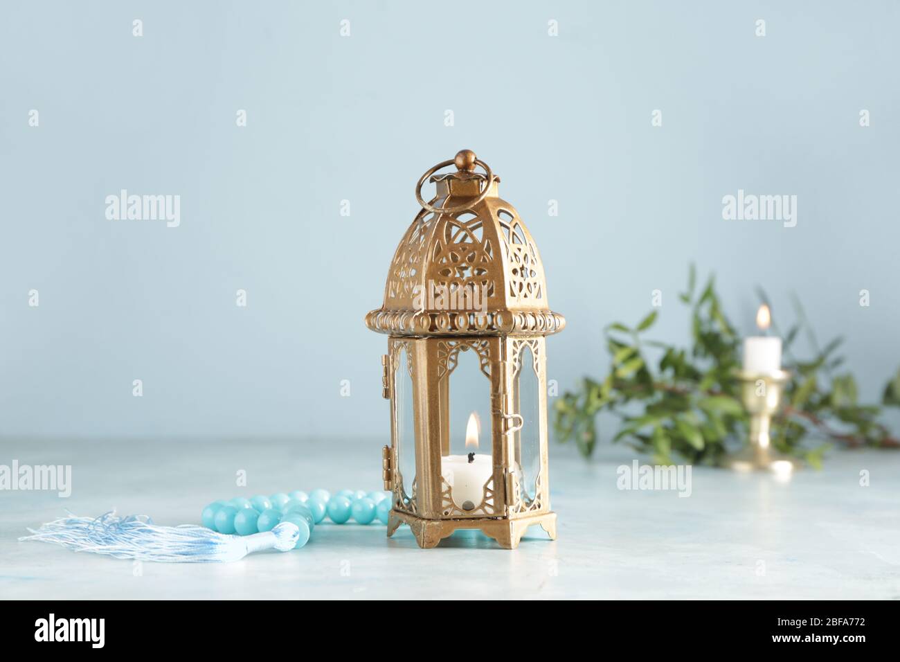 Muslim lamp and tasbih on color background Stock Photo - Alamy