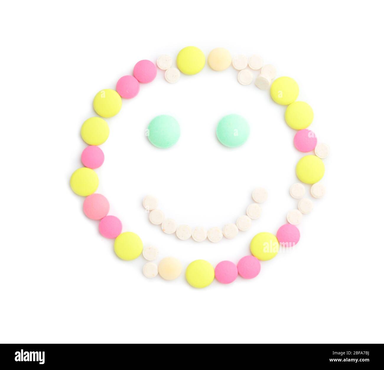 Happy face made of pills on white background Stock Photo - Alamy