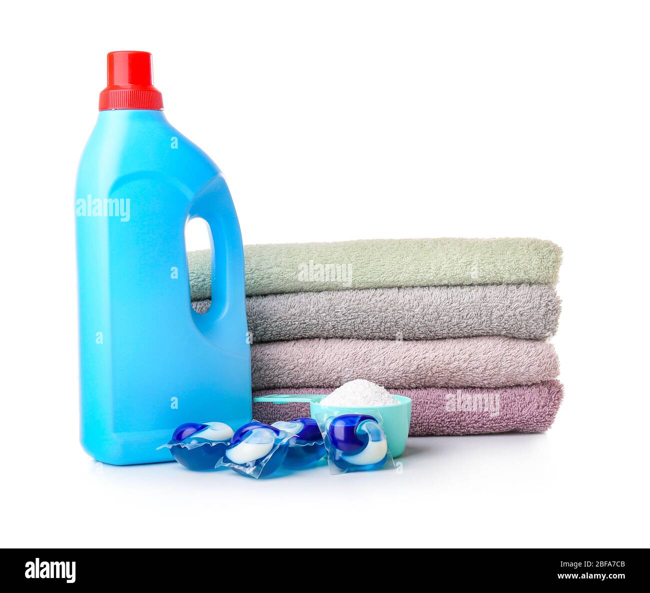Towels and laundry detergents on white background Stock Photo - Alamy