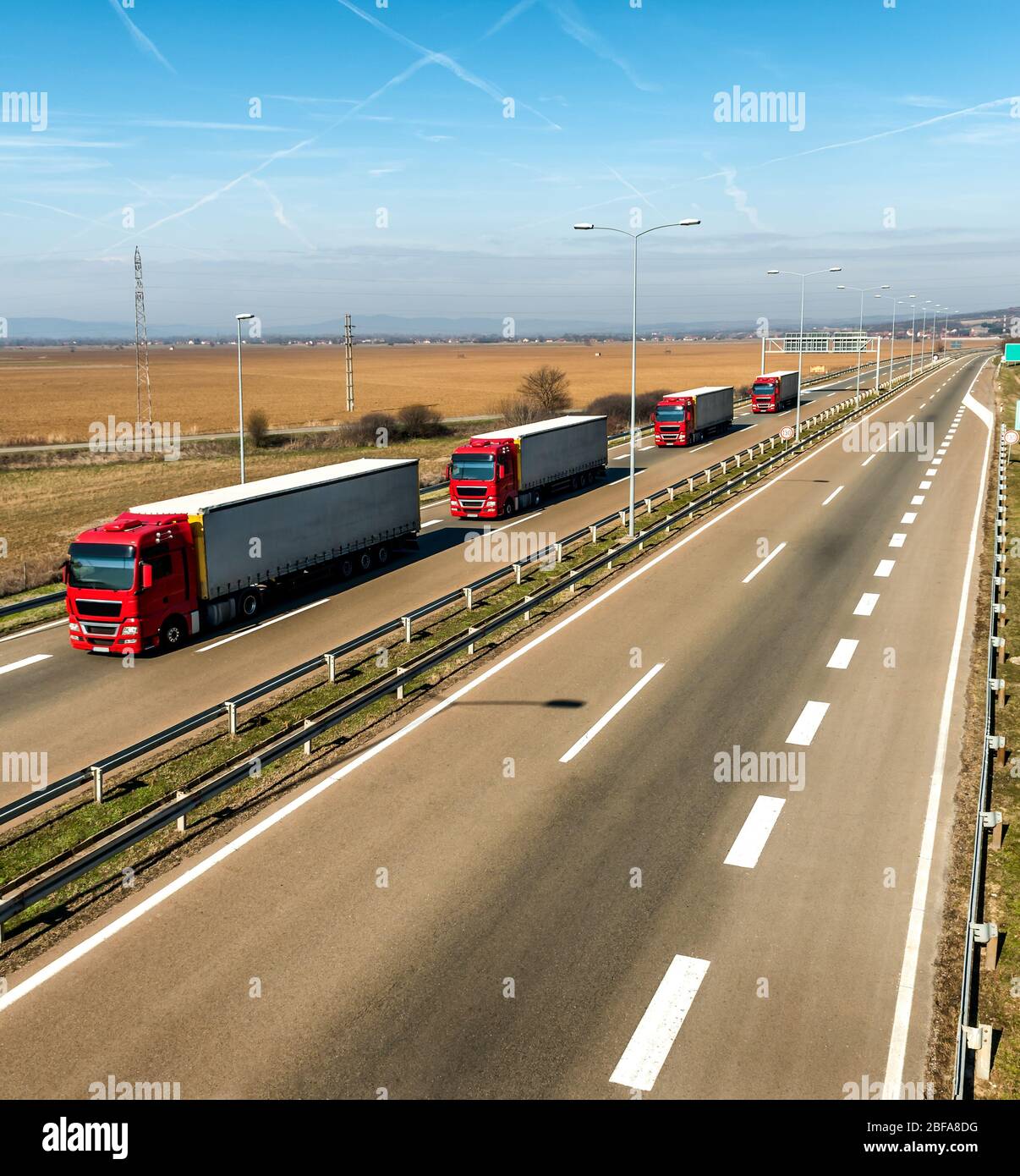 Convoy of transportation trucks in line as a caravan or convoy on a ...