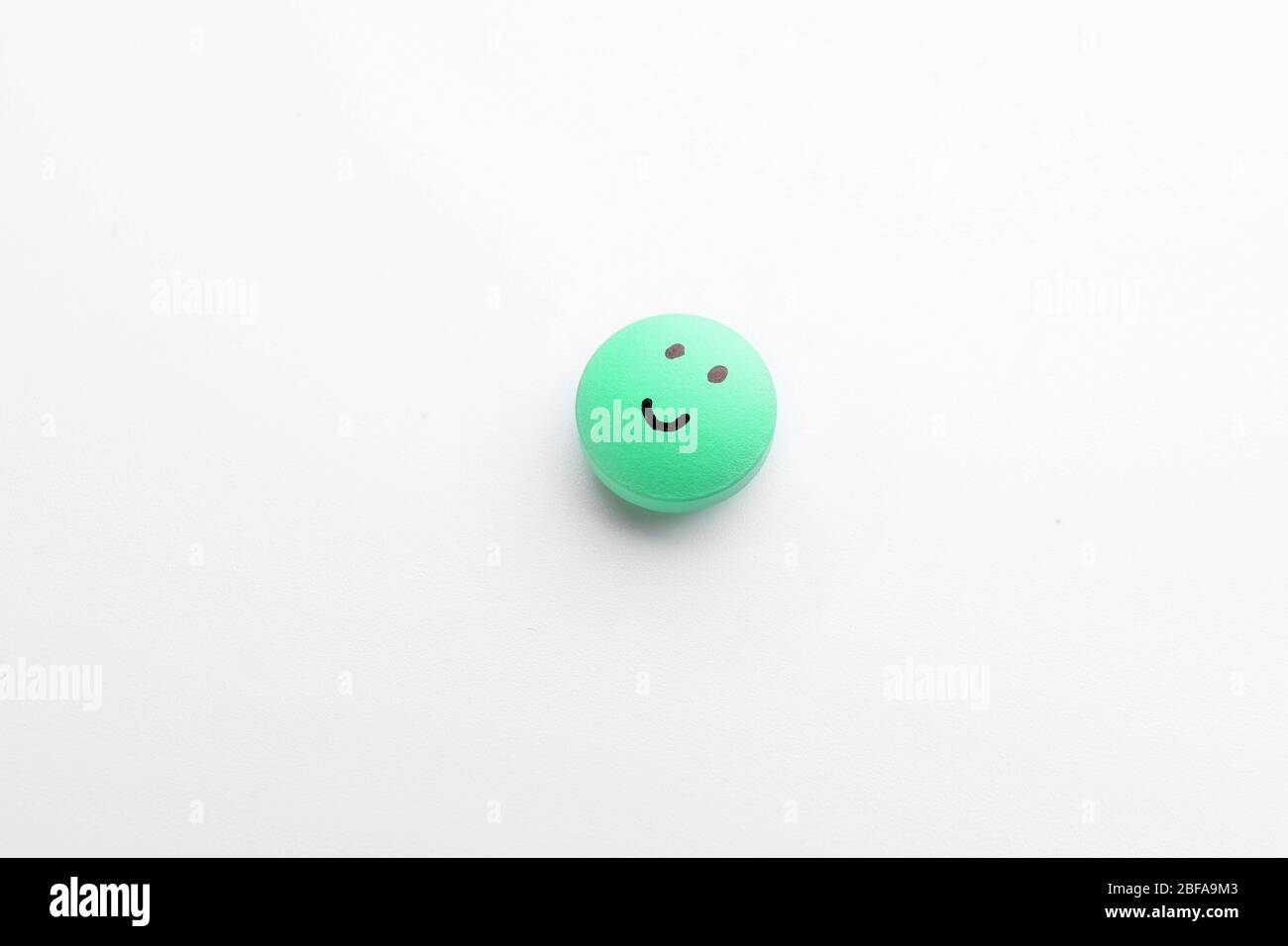 Pill with drawn face on white background Stock Photo - Alamy