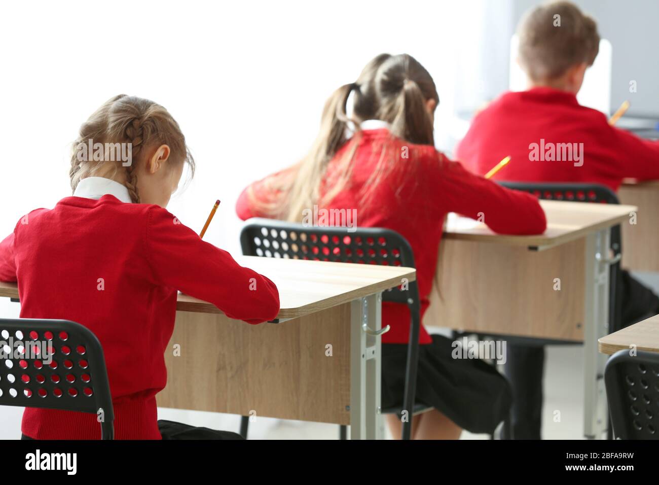 Pupils passing exam at school Stock Photo - Alamy