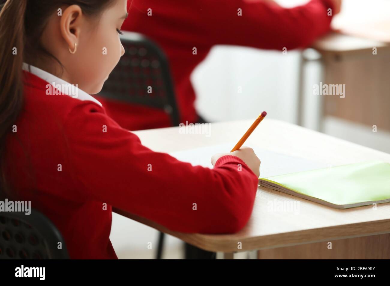 Pupils passing exam at school Stock Photo - Alamy