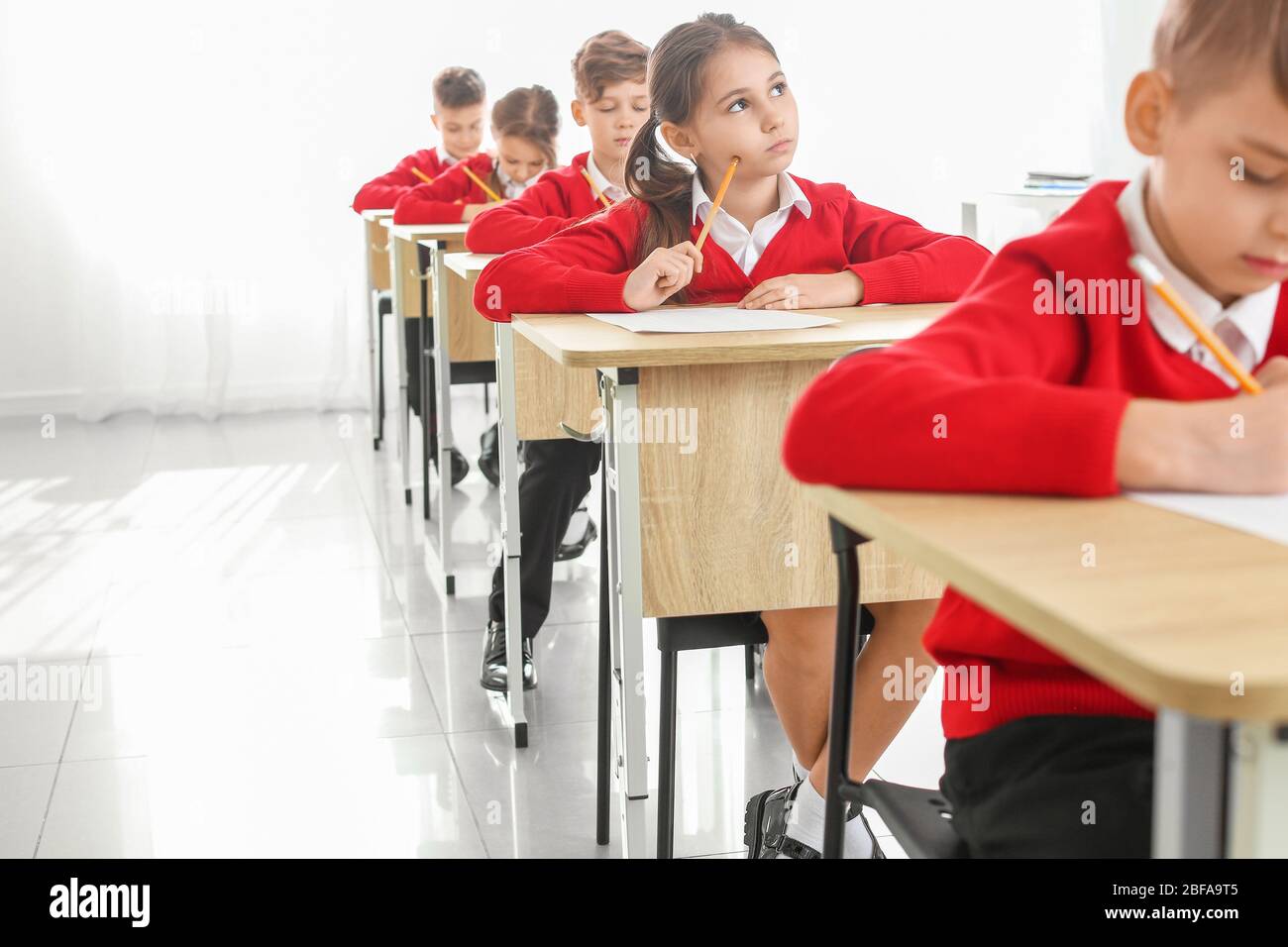 Pupils passing exam at school Stock Photo - Alamy