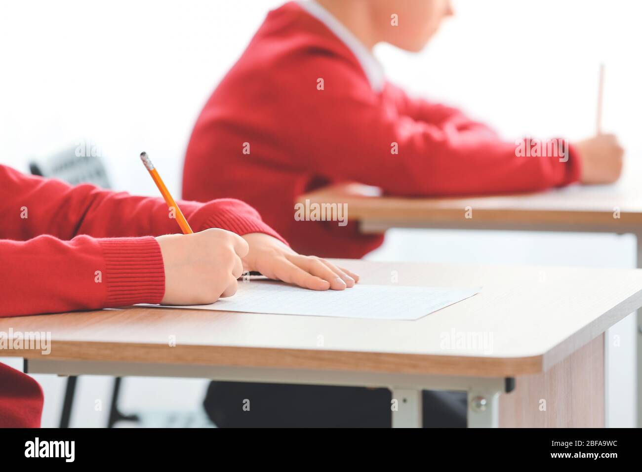 Pupils passing exam at school Stock Photo - Alamy