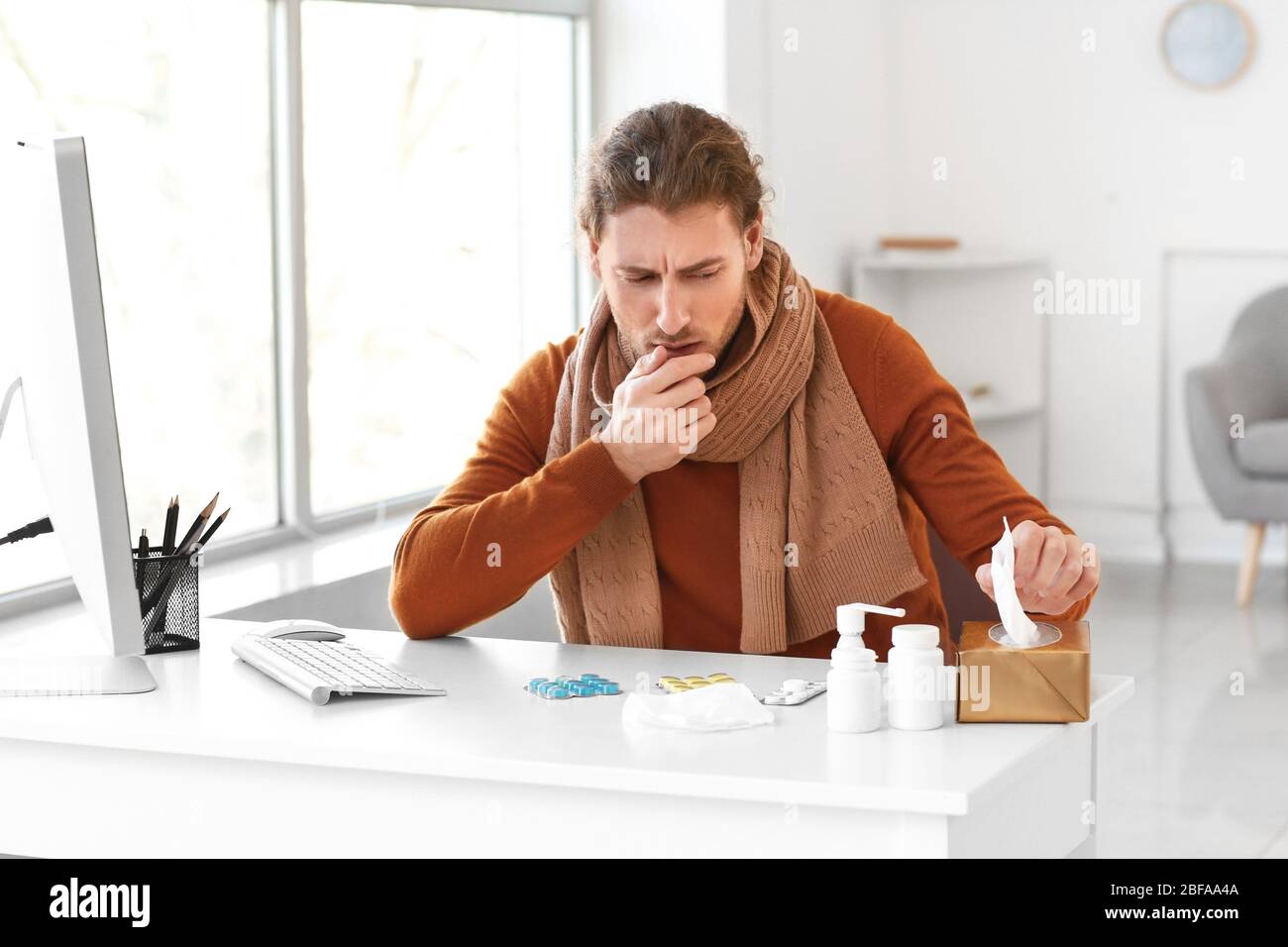ill young man at workplace Stock Photo - Alamy