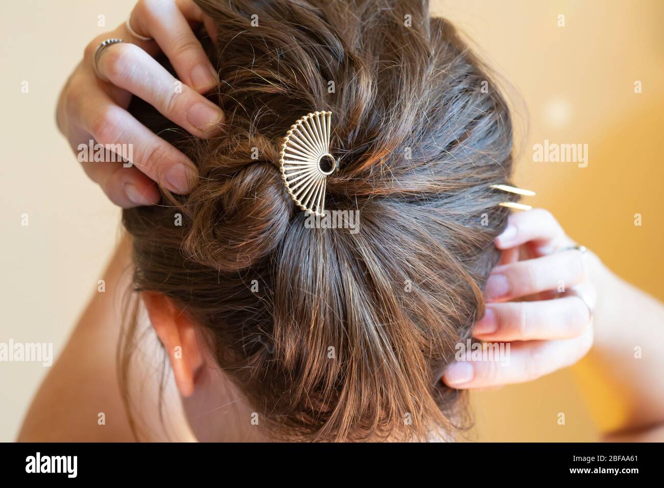 Woman wearing metal hair pin in her hair bin Stock Photo - Alamy