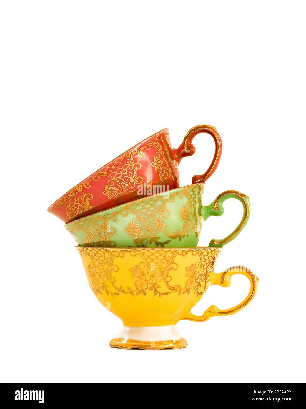 Stack of three brightly coloured vintage china tea cups in yellow ...