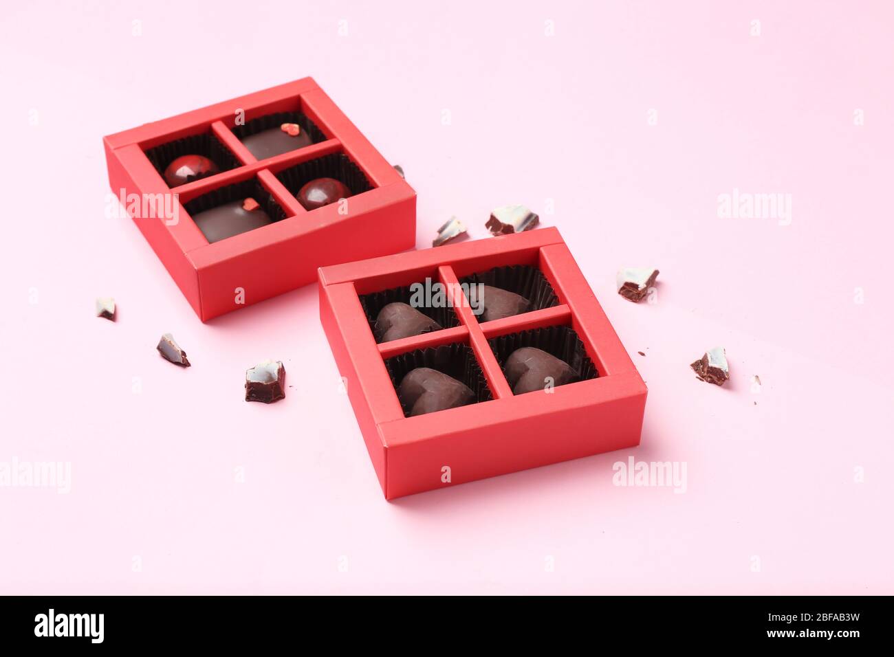 Boxes with delicious chocolate candies on color background Stock Photo ...