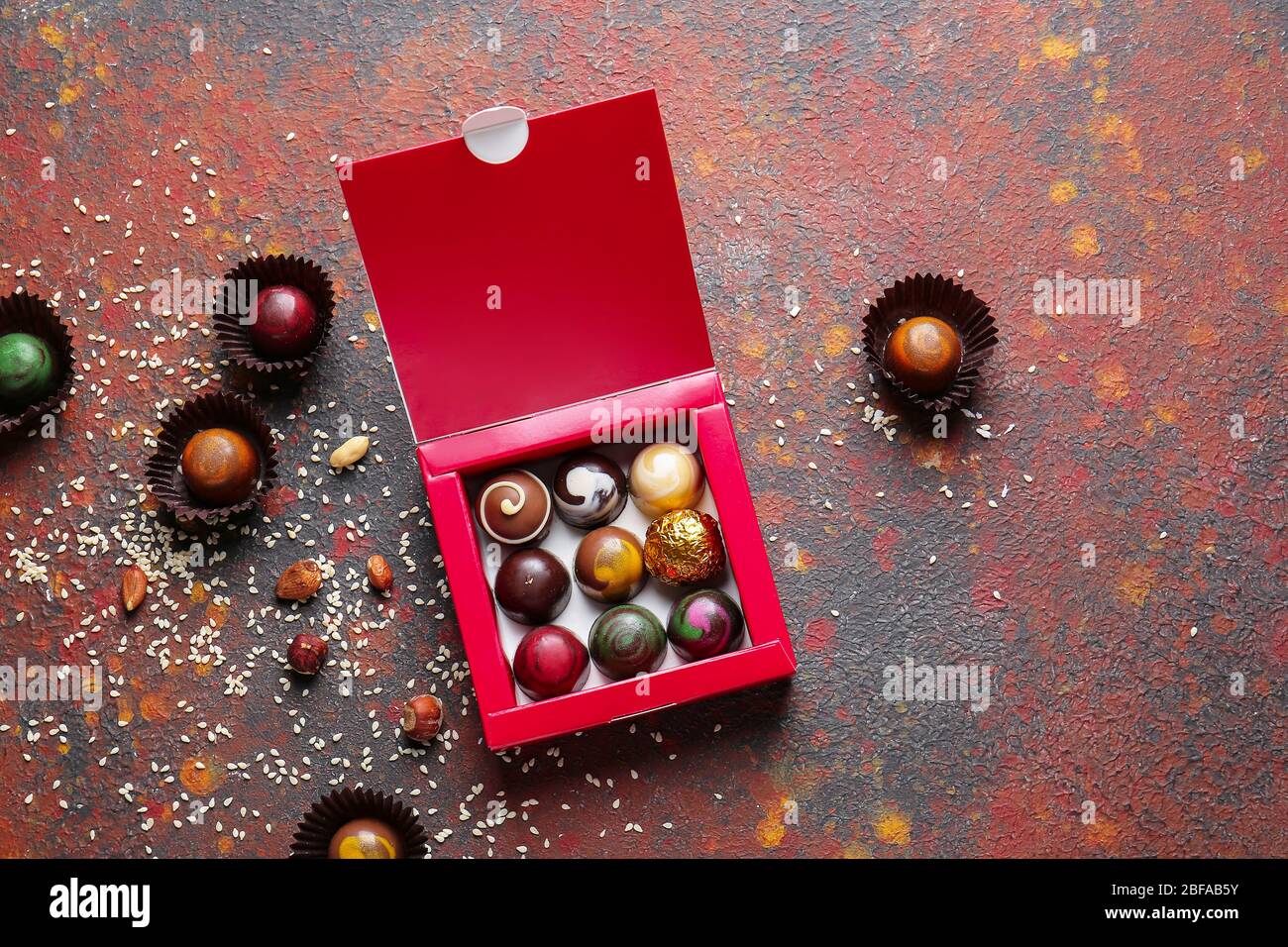 Box with delicious chocolate candies on grunge background Stock Photo ...