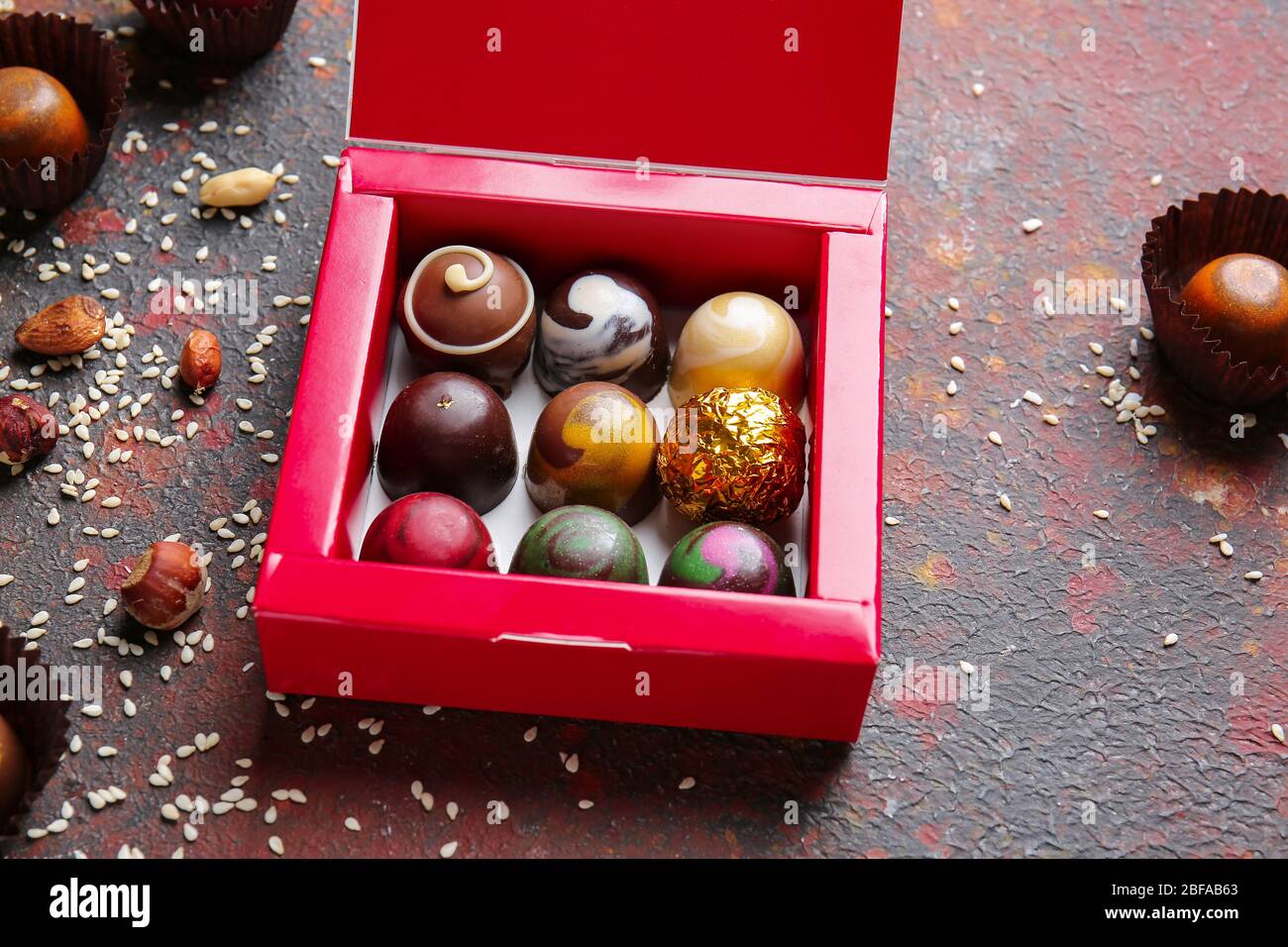 Box with delicious chocolate candies on grunge background Stock Photo ...