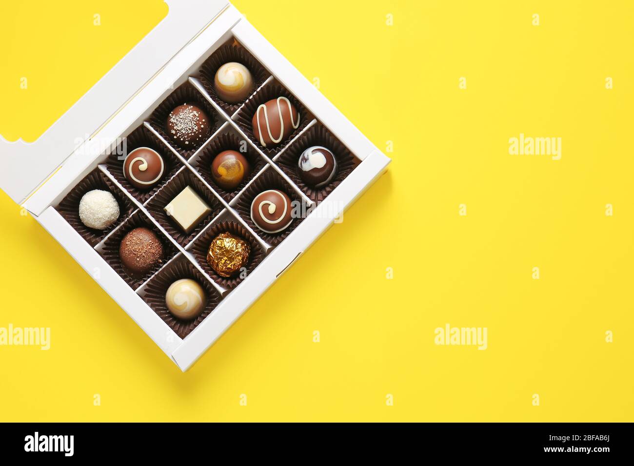 Box with delicious chocolate candies on color background Stock Photo ...