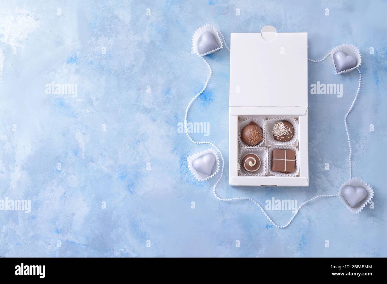 Box with delicious candies on color background Stock Photo - Alamy