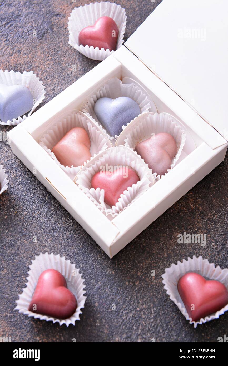 Box with delicious candies on dark background Stock Photo - Alamy