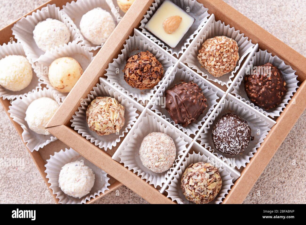 Boxes with delicious candies on grey background Stock Photo - Alamy