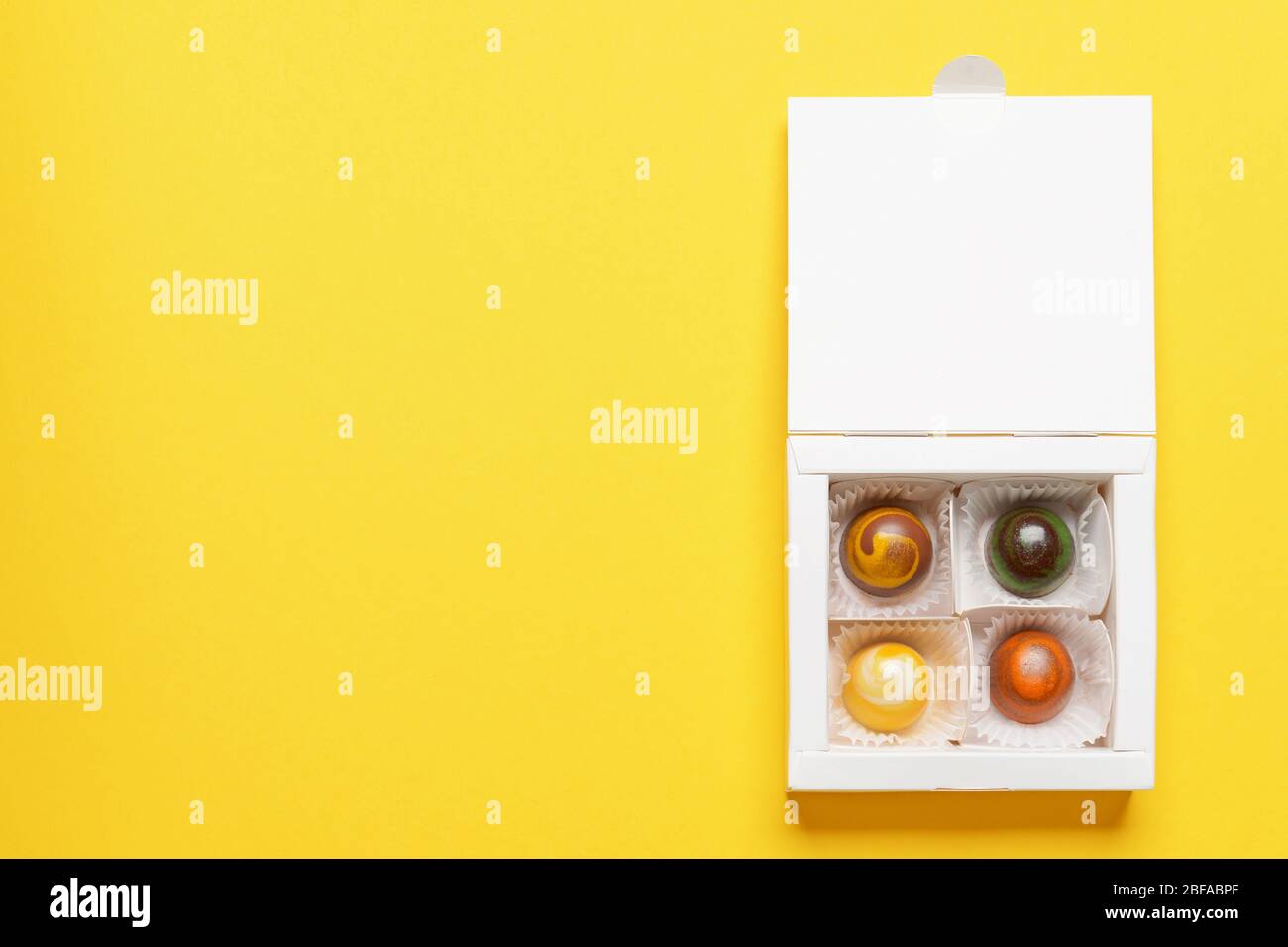 Box with delicious candies on color background Stock Photo - Alamy