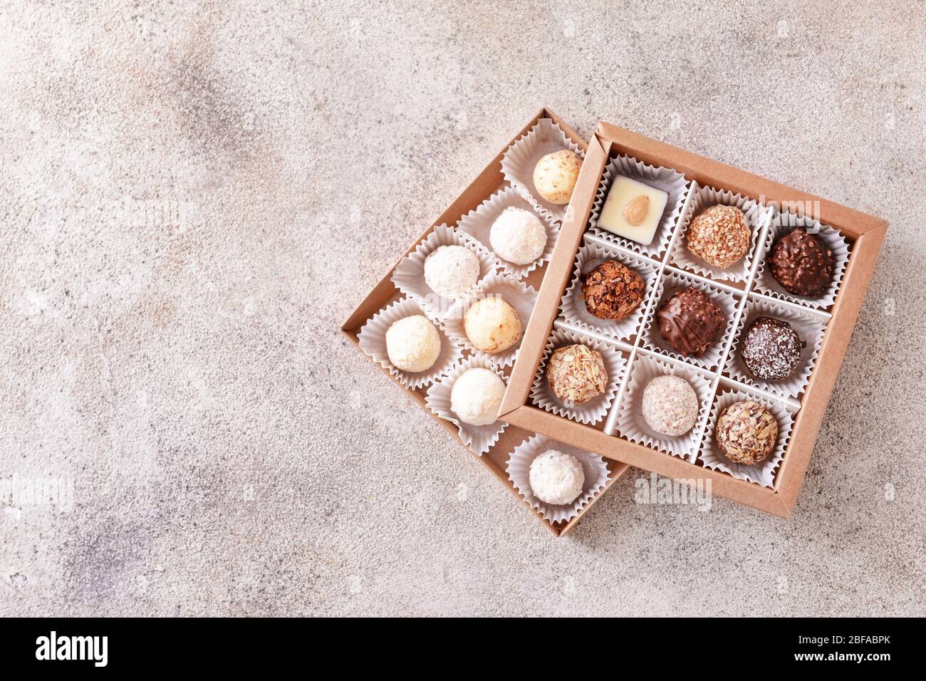 Boxes with delicious candies on grey background Stock Photo - Alamy