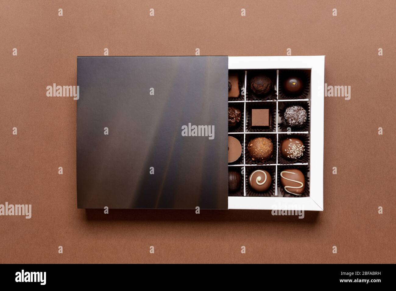 Box with delicious candies on color background Stock Photo - Alamy