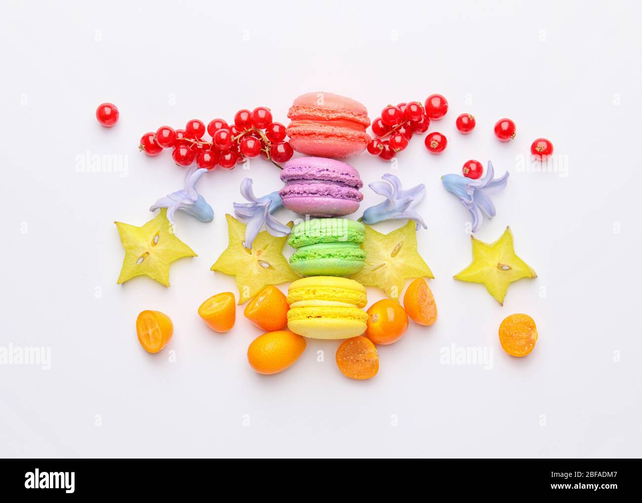 Tasty macarons with fruits on white background Stock Photo - Alamy
