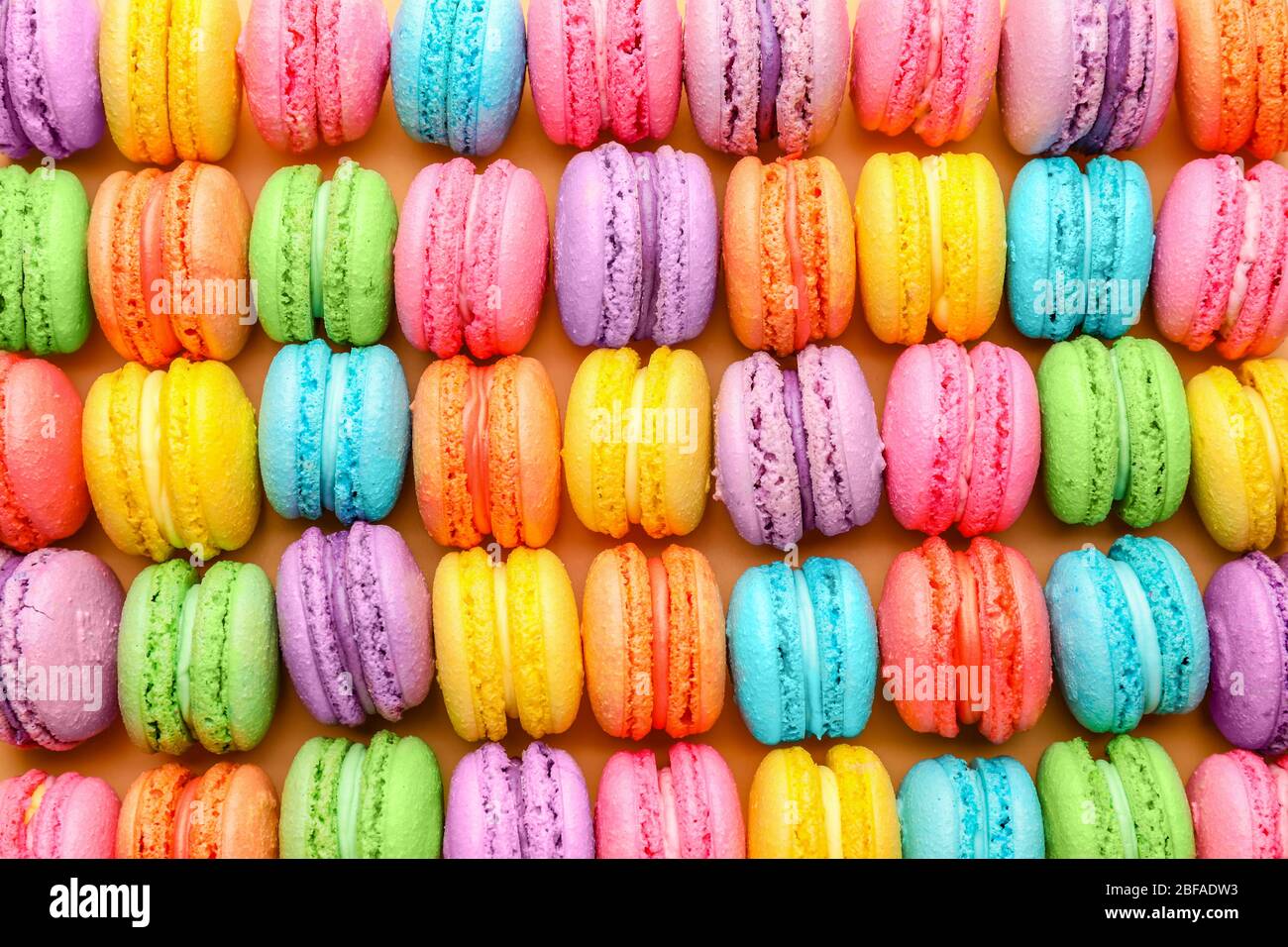 Many tasty macarons as background Stock Photo - Alamy