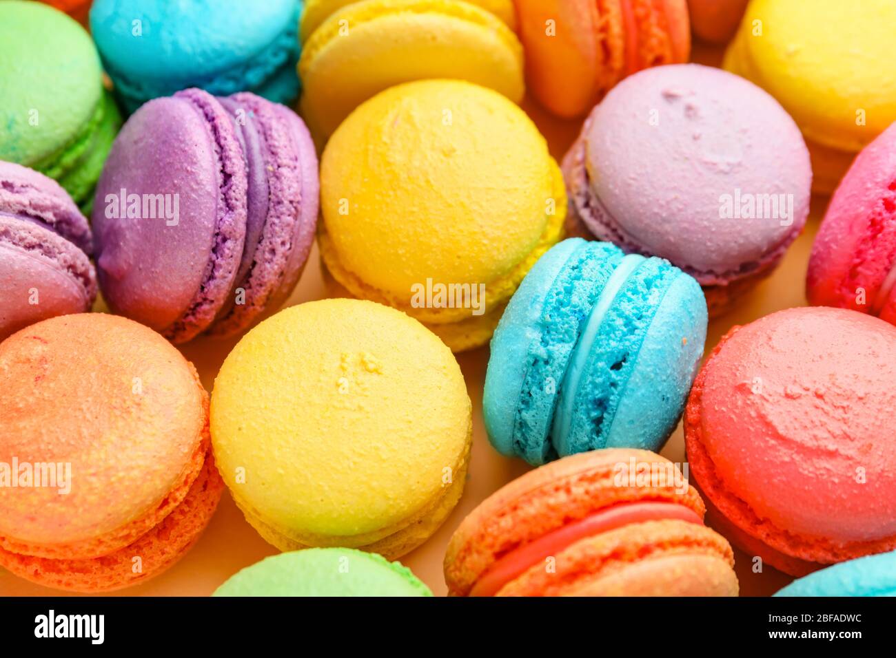 Many tasty macarons as background Stock Photo - Alamy
