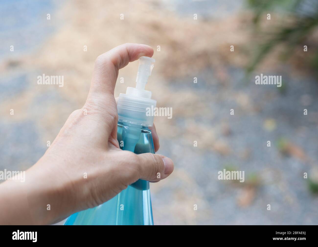 Hand of people applying alcohol spray or anti bacteria spray to prevent ...