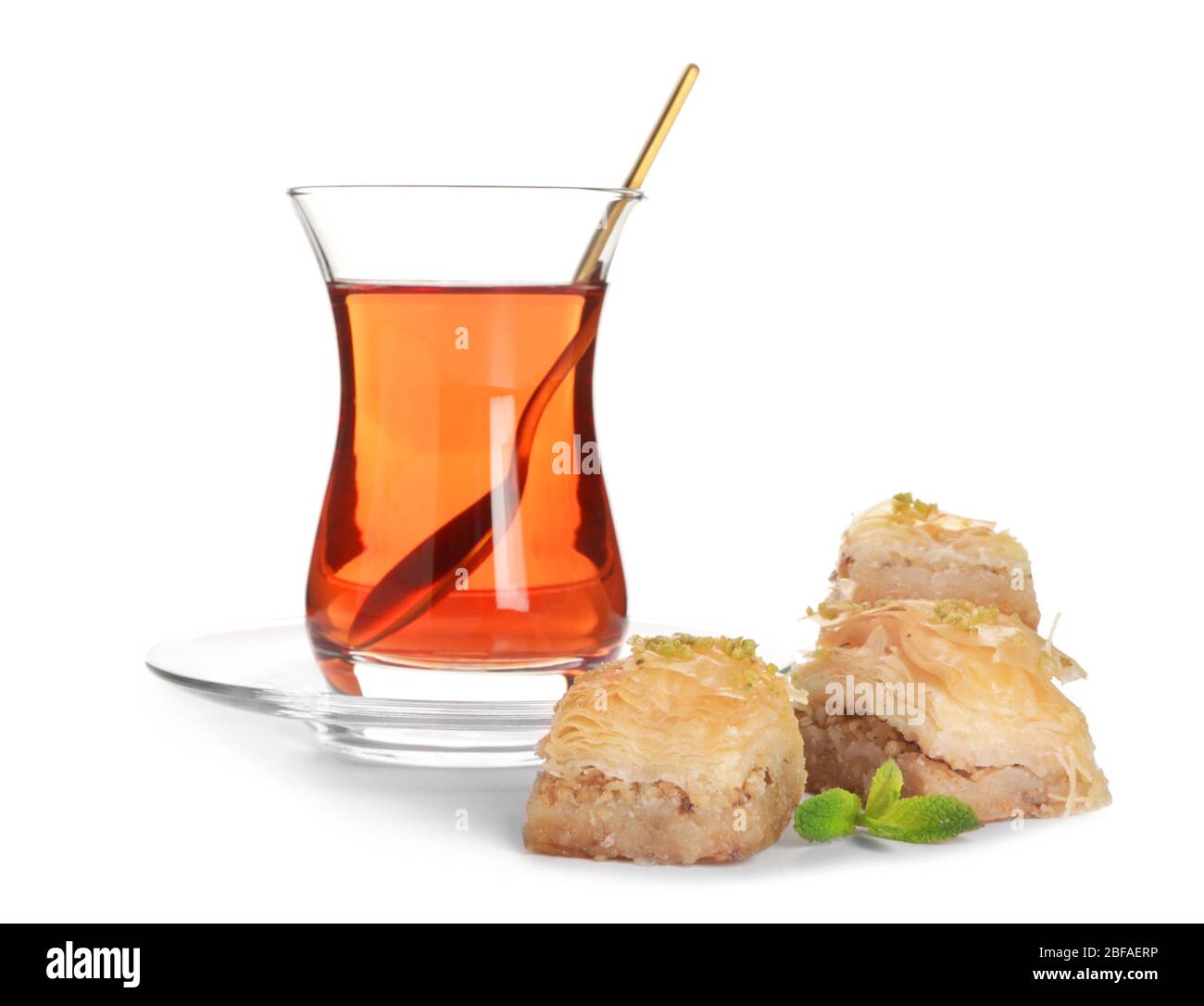 Tasty Turkish tea with sweets on white background Stock Photo - Alamy