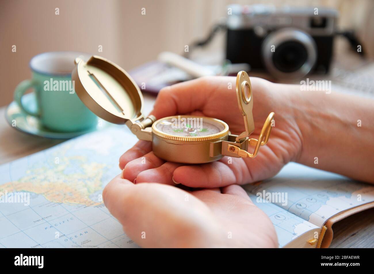 Vintage compass in female hands. Young woman planning her vacation with ...