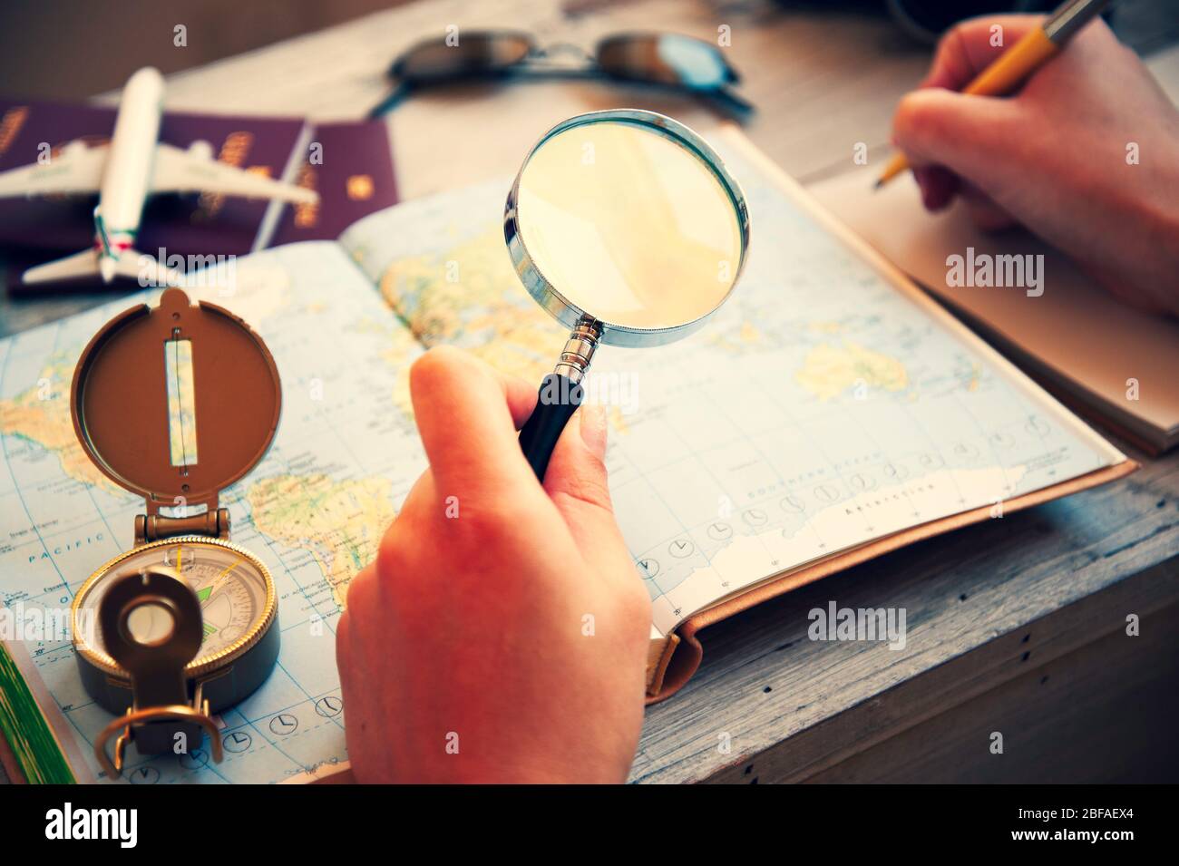 Young woman planning her vacation with travel map. She's looking for ...