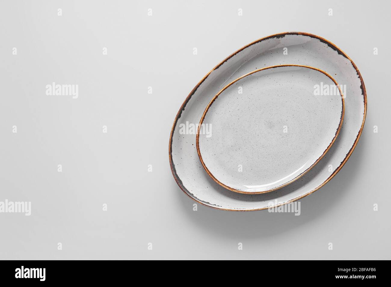 Clean plates on white background Stock Photo - Alamy