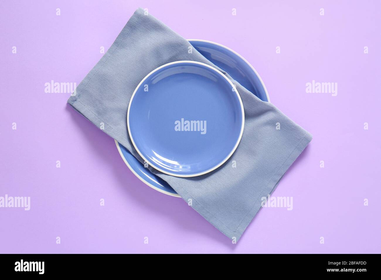 Clean plates on color background Stock Photo - Alamy