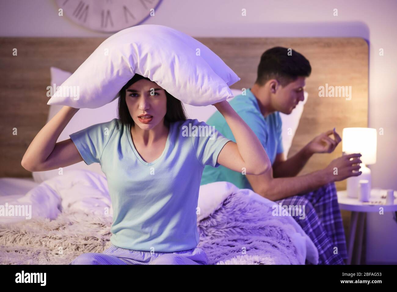 Angry woman suffering from insomnia in bedroom Stock Photo - Alamy