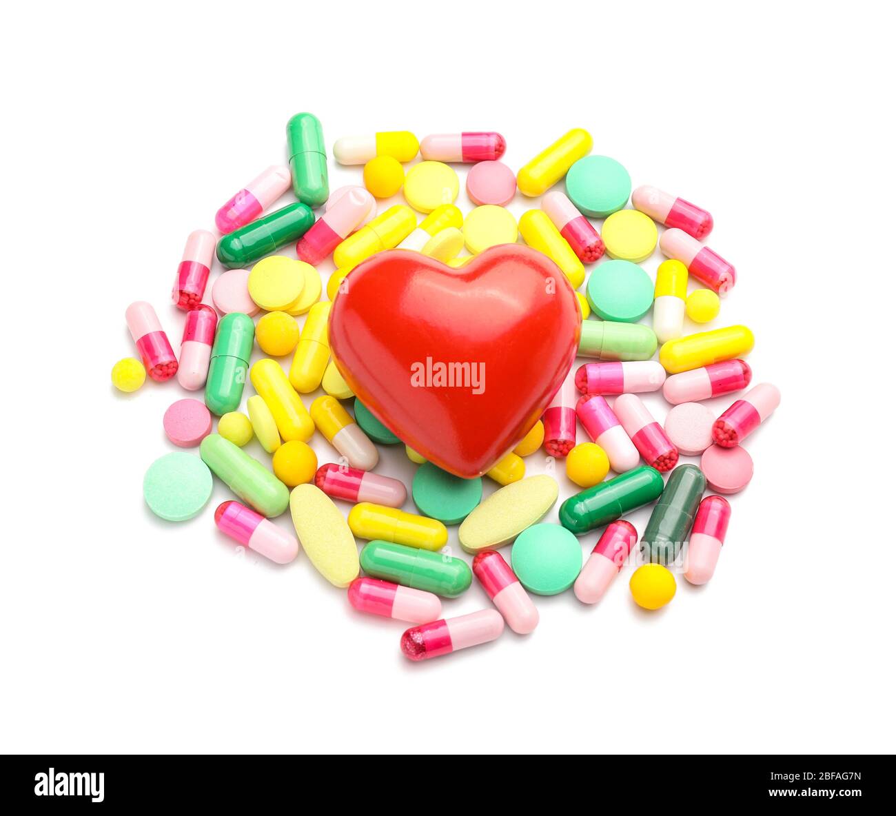 Red heart and pills on white background. Cardiology concept Stock Photo ...