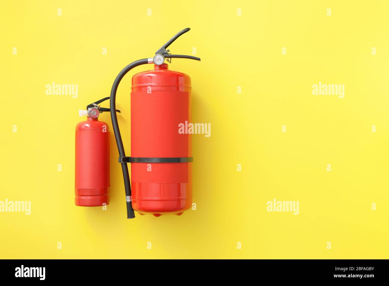 Fire extinguishers on color background Stock Photo - Alamy