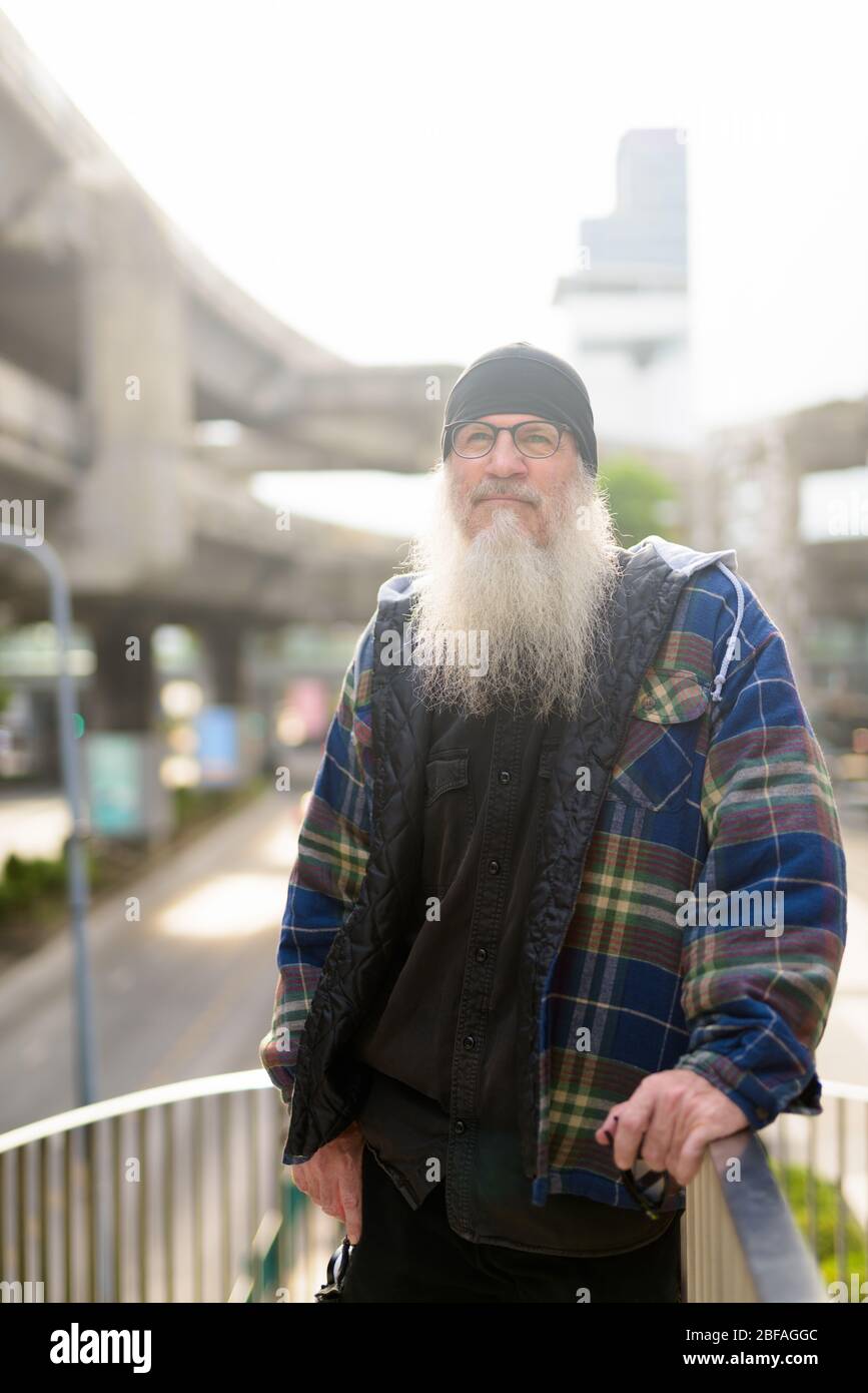 Mature Bearded Hipster Man Thinking At Footbridge In The City Stock