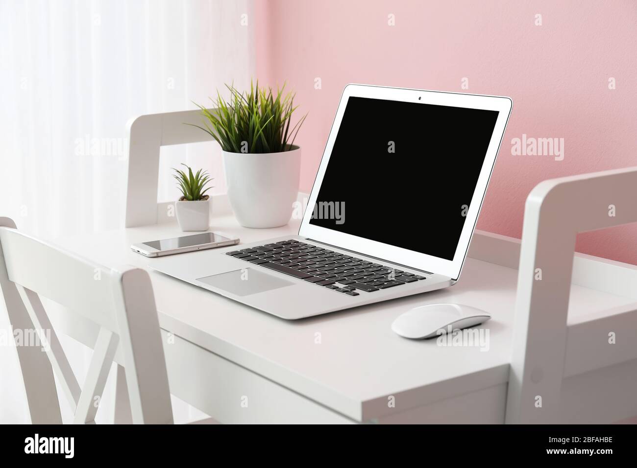Modern laptop on workplace in room Stock Photo - Alamy