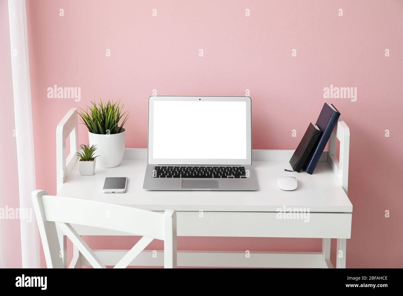 Modern laptop on workplace in room Stock Photo - Alamy