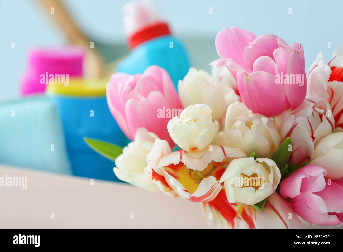 Spring flowers with cleaning supplies, closeup Stock Photo - Alamy