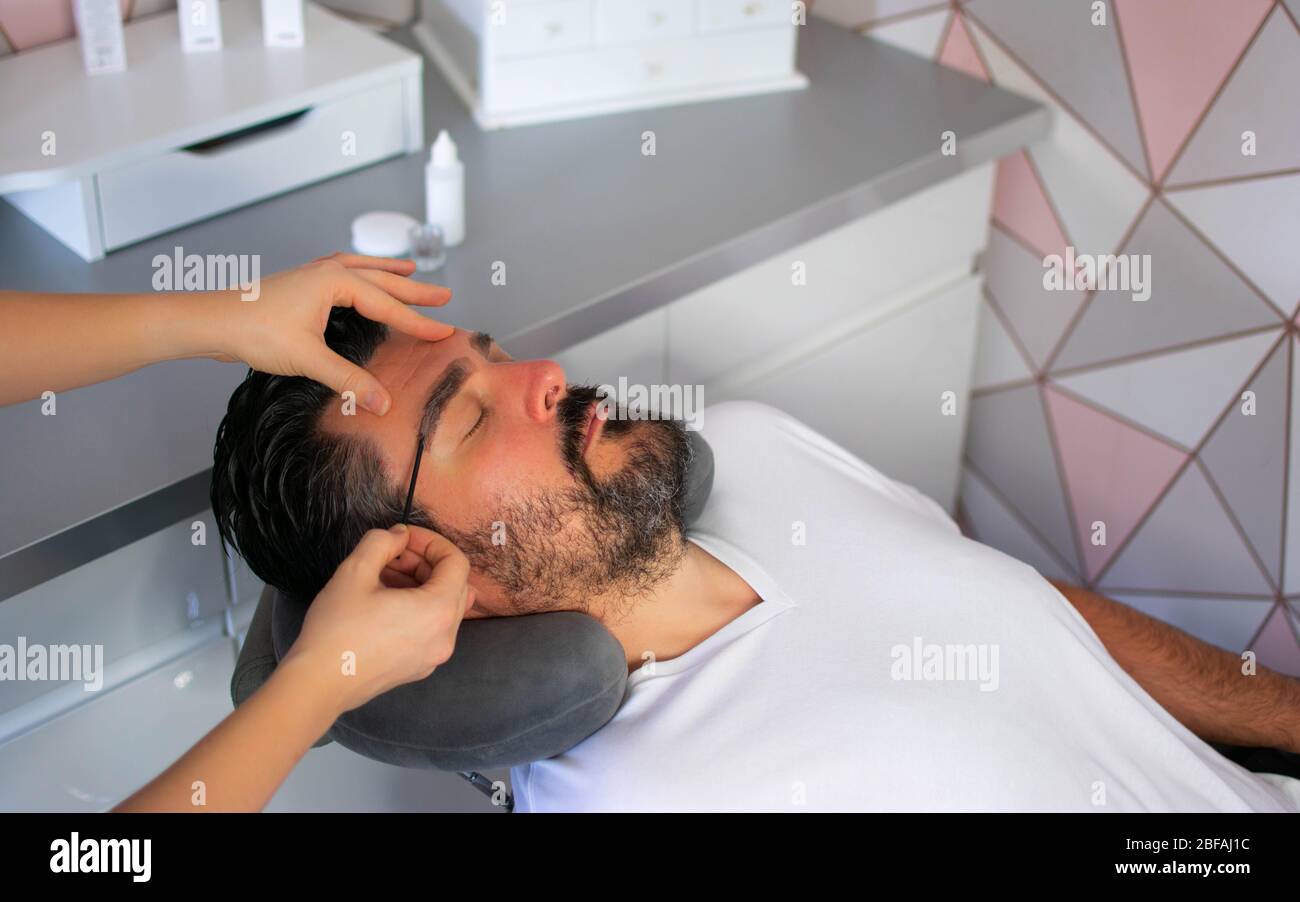 White man with dark hair and beard enjoying beauty treatments. Male ...