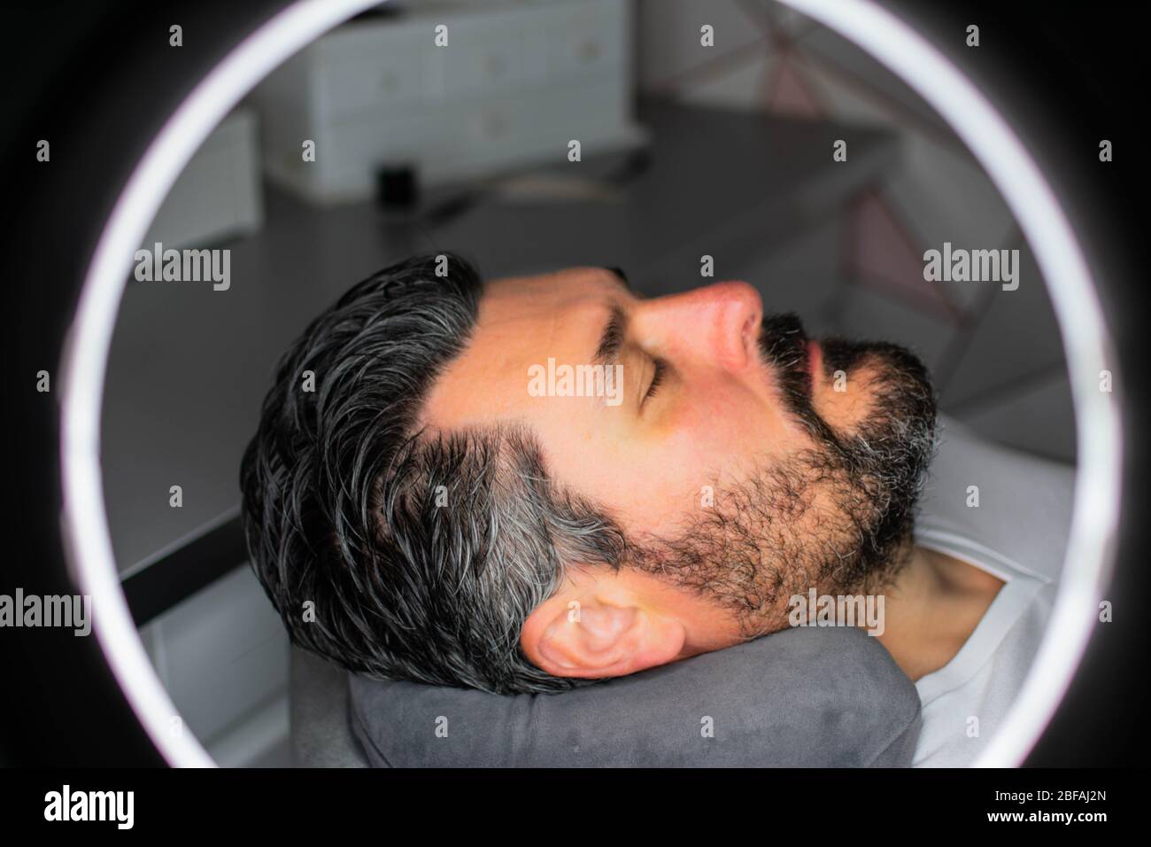 White man with dark hair and beard enjoying beauty treatments. Male ...