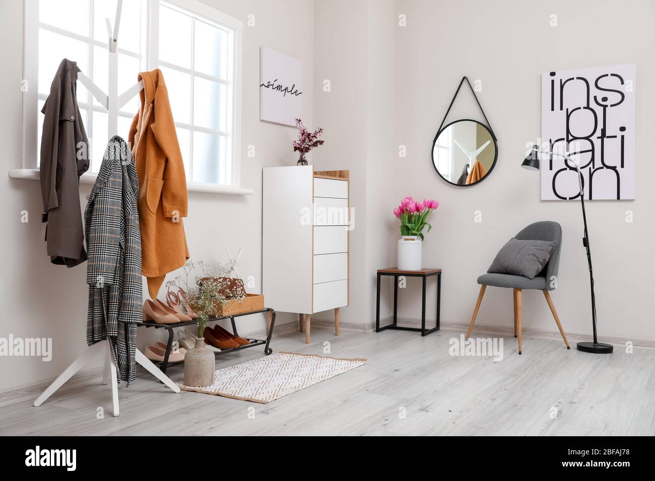 Stylish interior of modern hall with spring flowers Stock Photo - Alamy