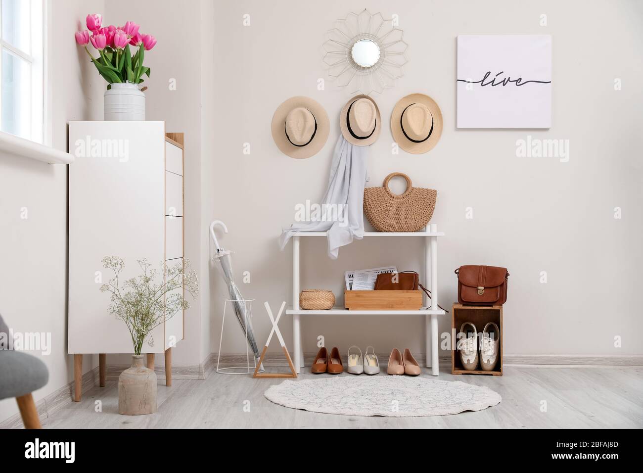 Stylish interior of modern hall with spring flowers Stock Photo - Alamy